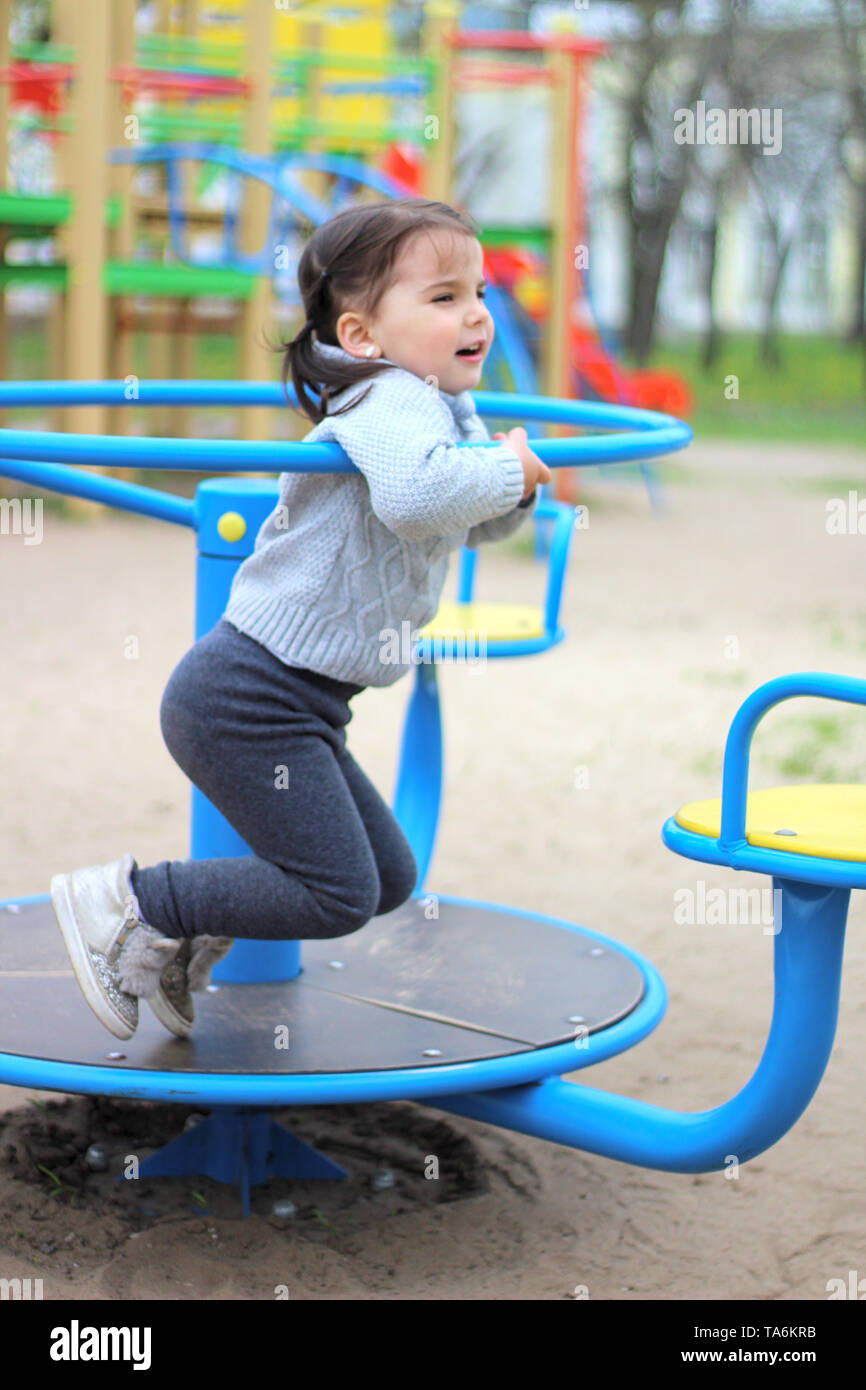 child rides on the carousel in the playground Stock Photo - Alamy