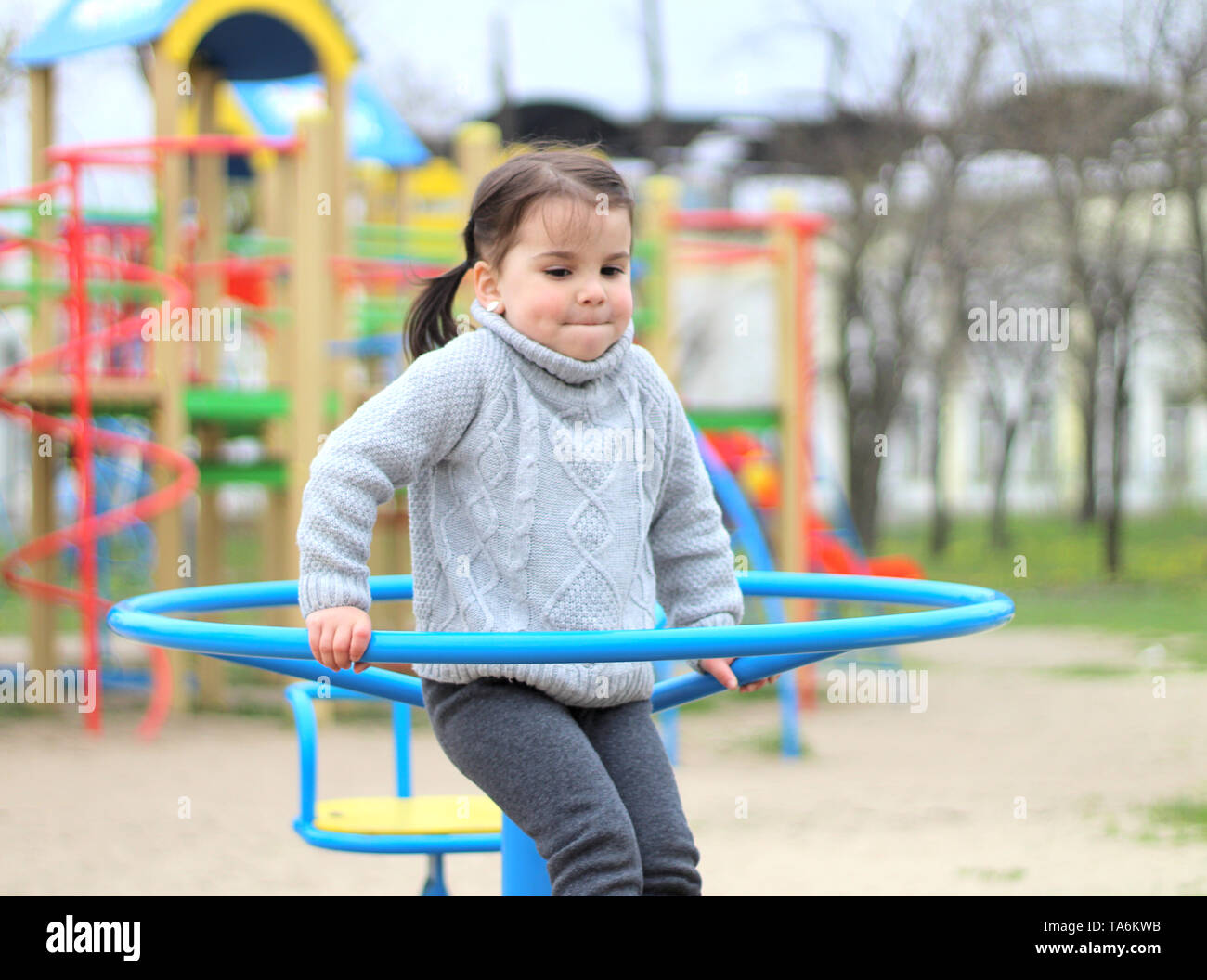 child rides on the carousel in the playground Stock Photo - Alamy