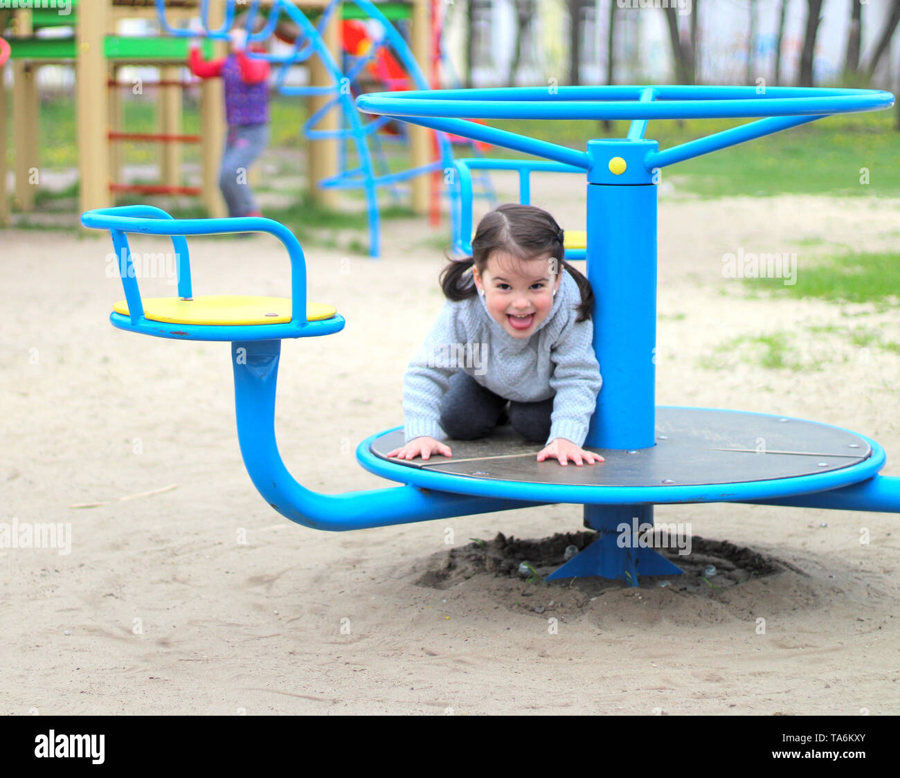 child rides on the carousel in the playground Stock Photo - Alamy