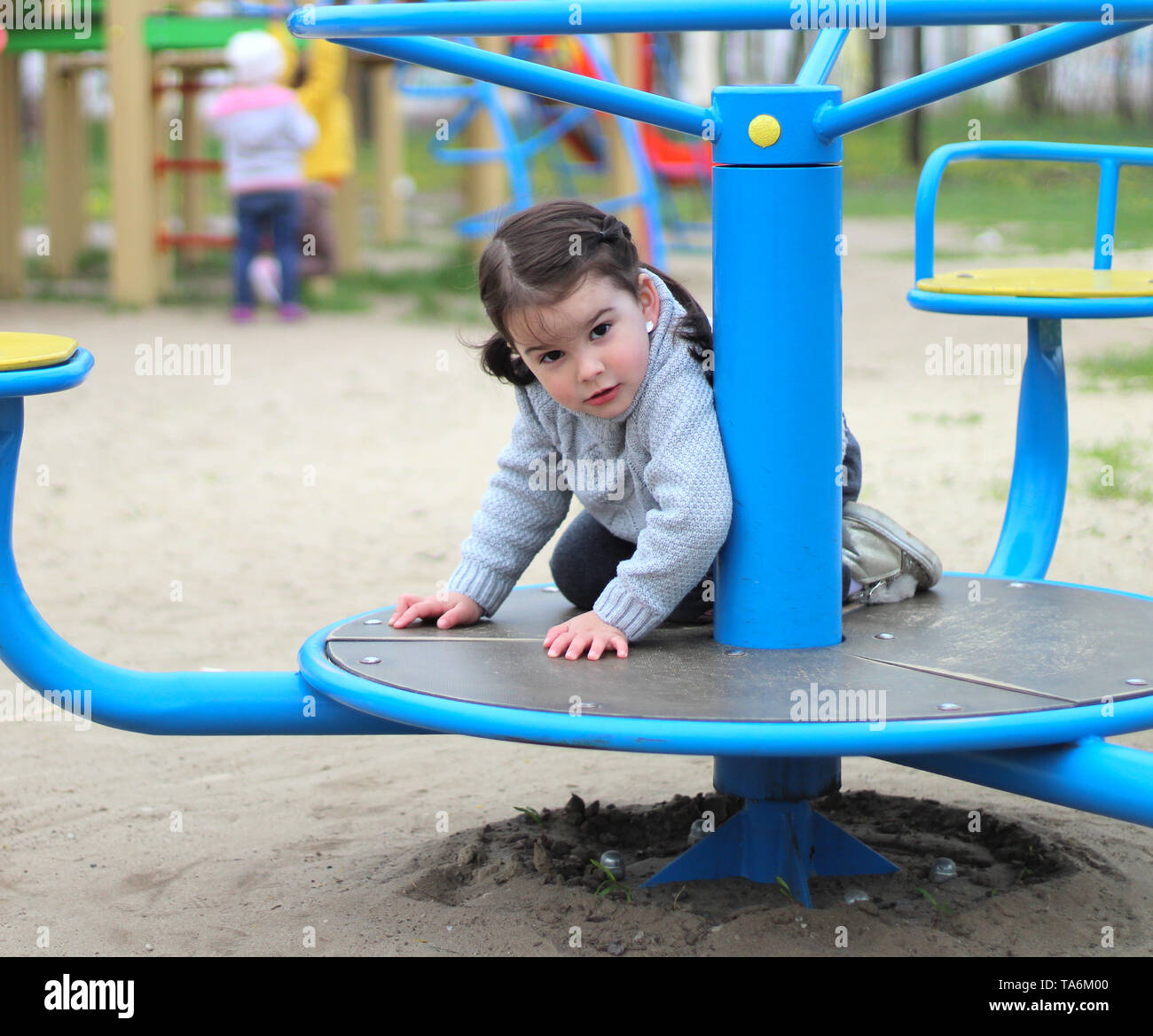child rides on the carousel in the playground Stock Photo - Alamy