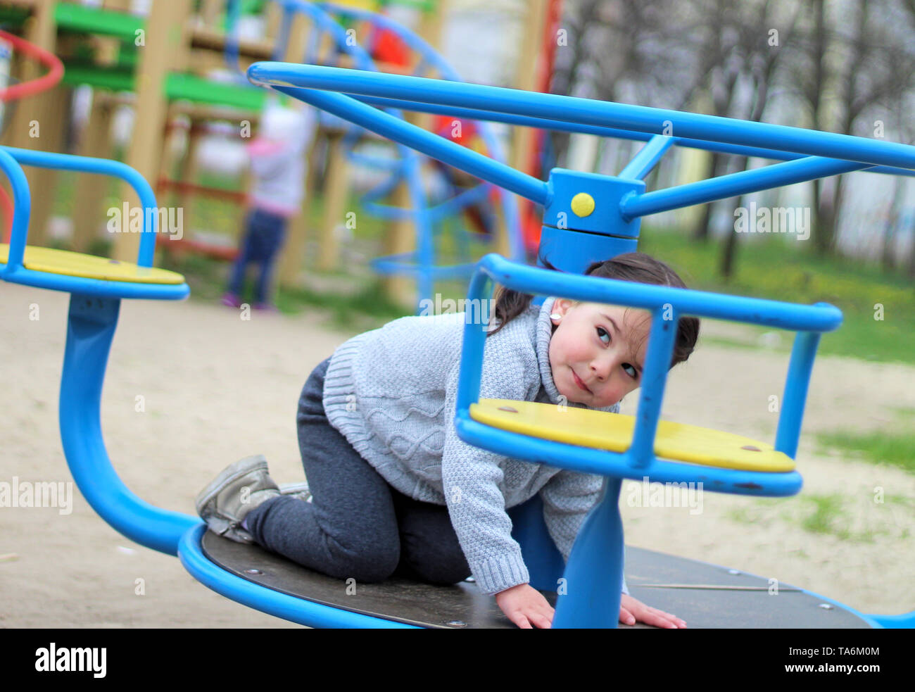 child rides on the carousel in the playground Stock Photo - Alamy