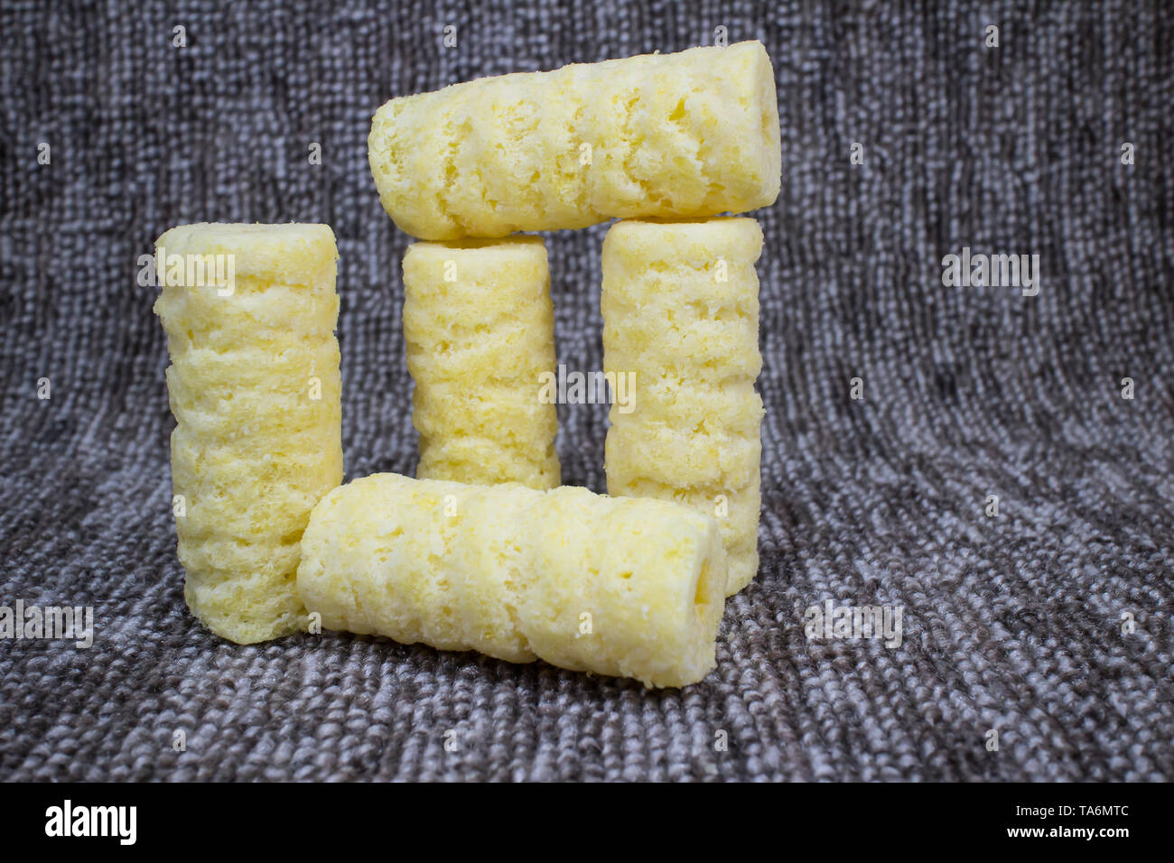 Roller corn snack, snack from corn product Stock Photo - Alamy