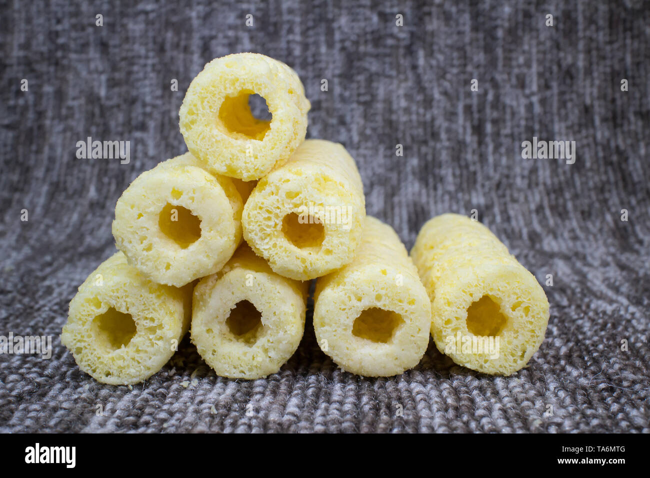Roller corn snack, snack from corn product Stock Photo - Alamy