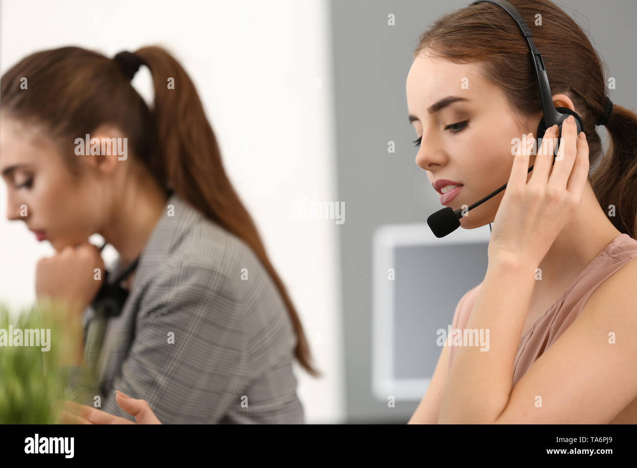 Technical support agents working in office Stock Photo - Alamy