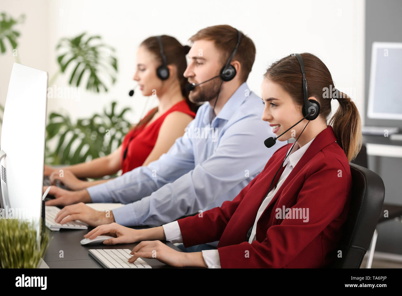 Technical support agents working in office Stock Photo - Alamy