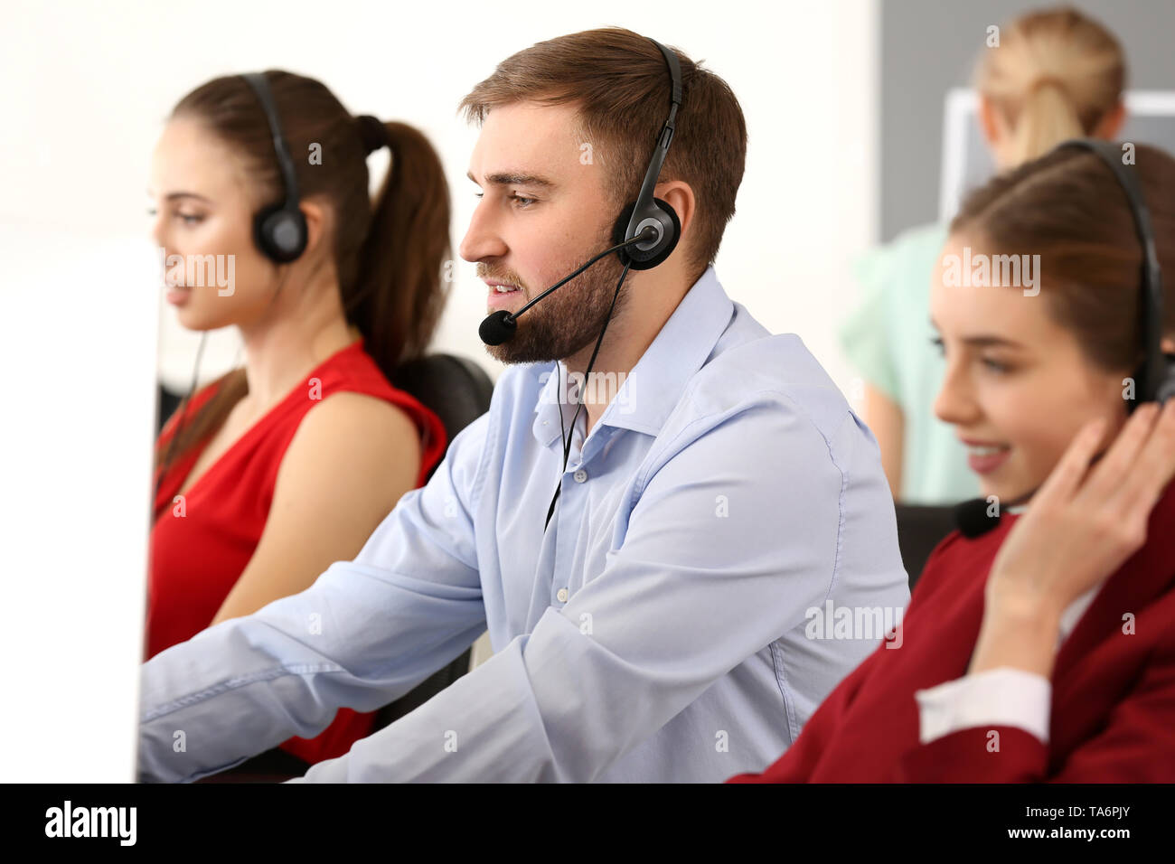 Technical support agents working in office Stock Photo - Alamy