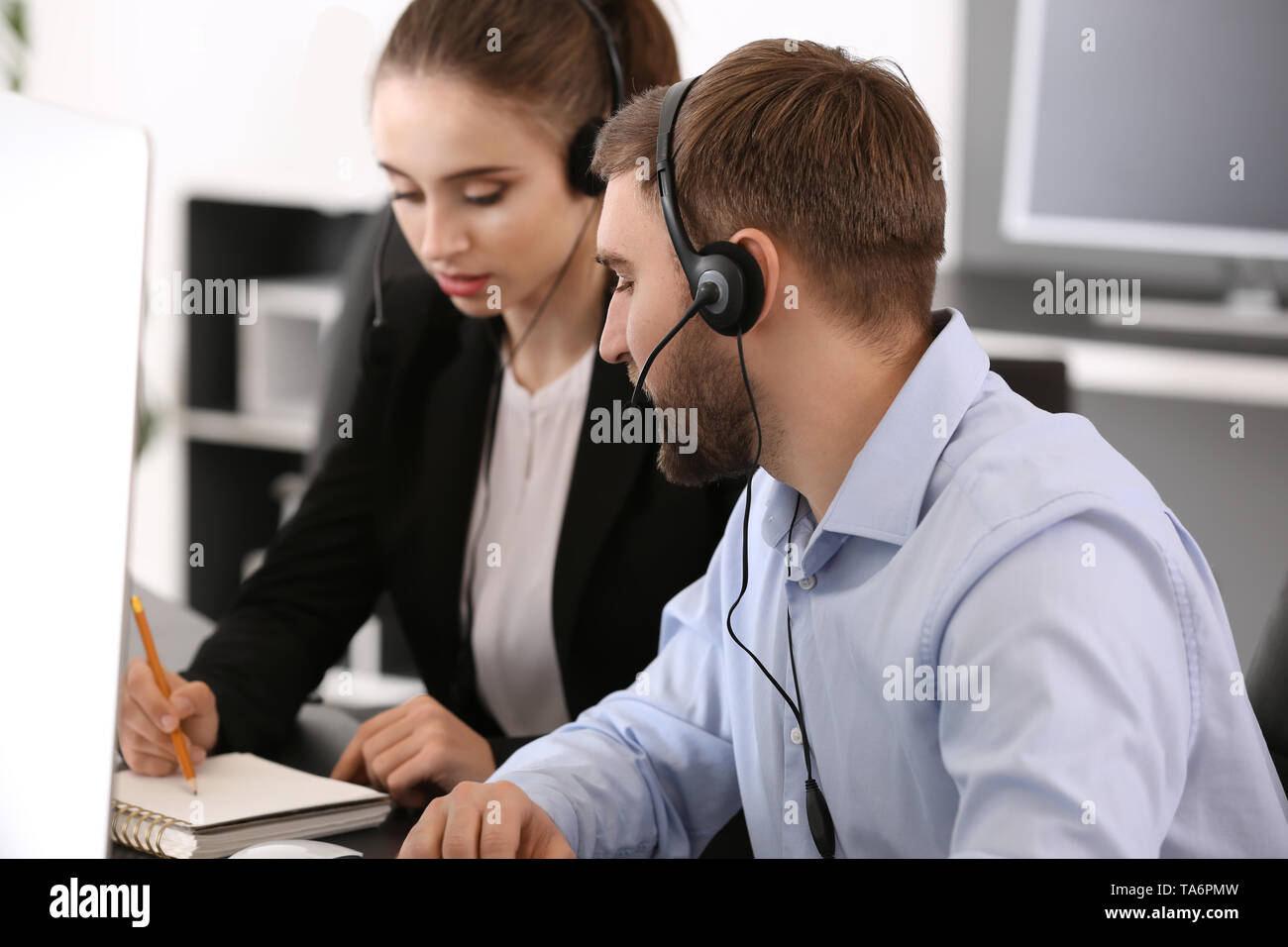Technical support agents working in office Stock Photo - Alamy