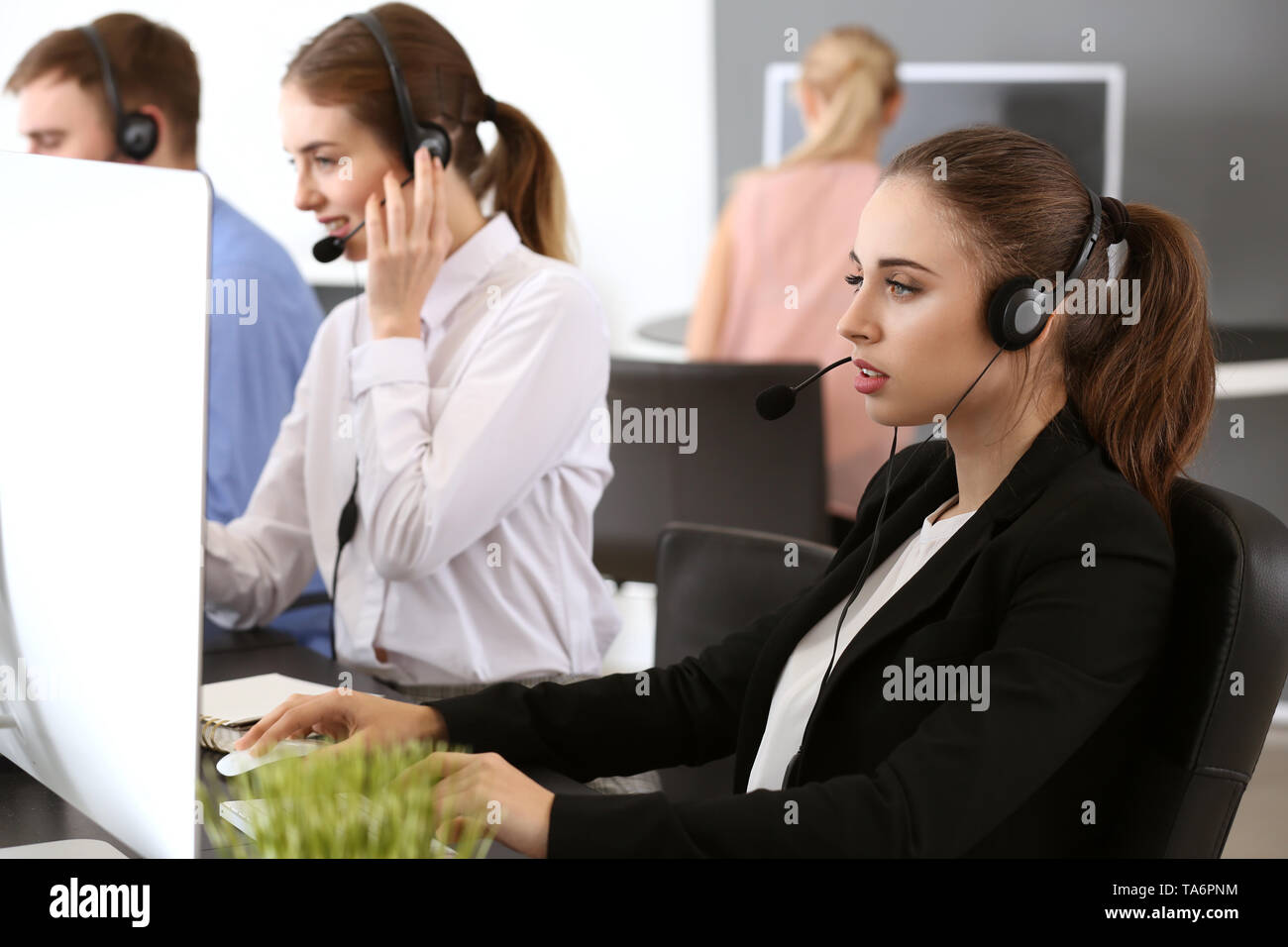 Technical support agents working in office Stock Photo - Alamy
