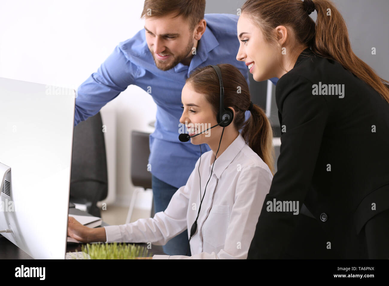 Technical support agents working in office Stock Photo - Alamy