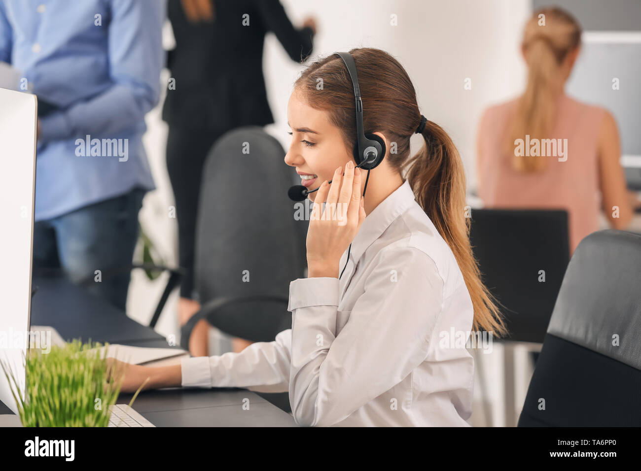 Female technical support agent working in office Stock Photo - Alamy