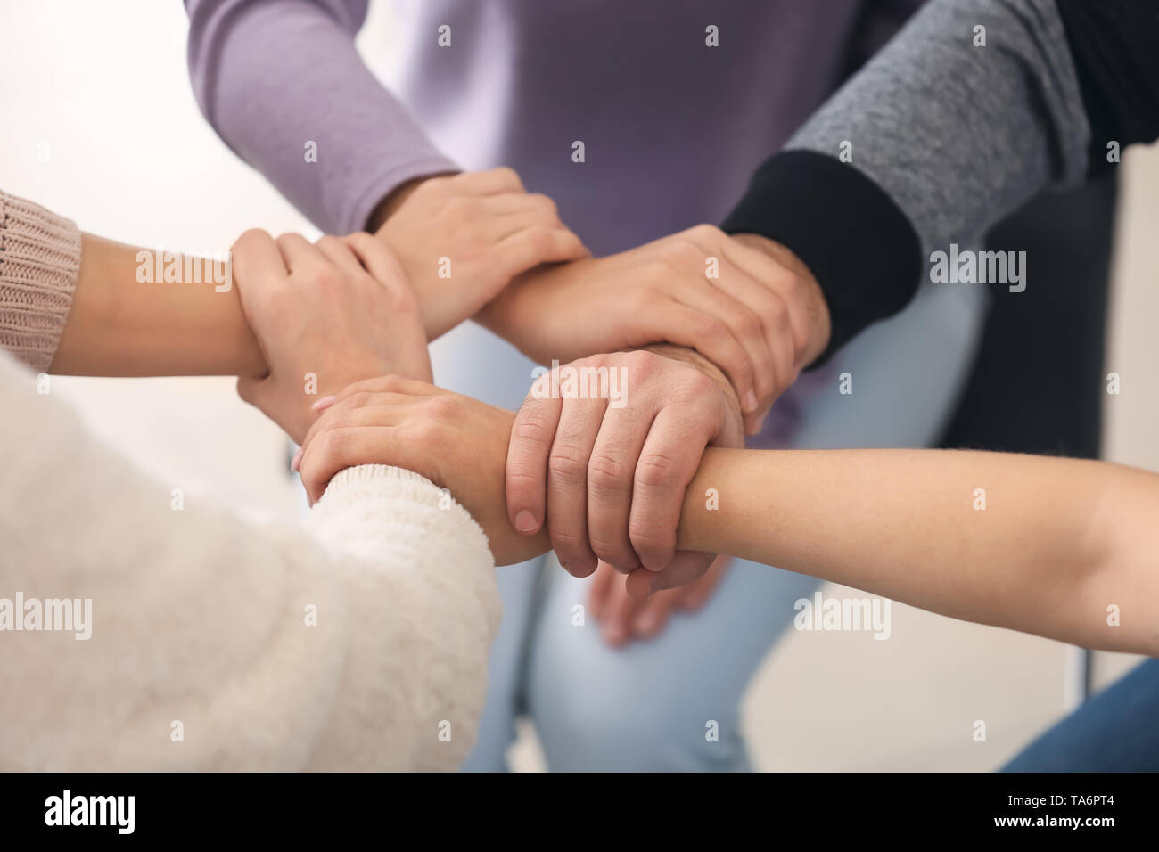 People holding hands together as symbol of support Stock Photo - Alamy