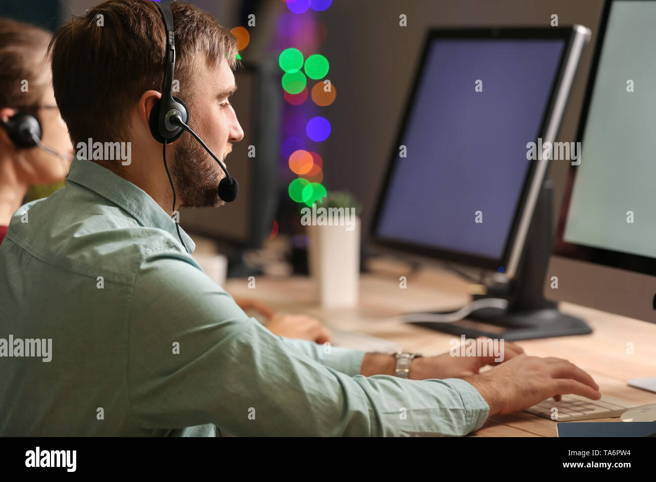 Male technical support agent working in office Stock Photo - Alamy