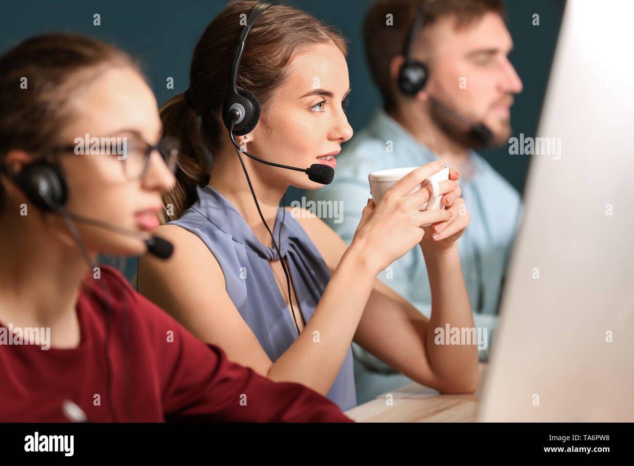 Female technical support agent working in office Stock Photo - Alamy