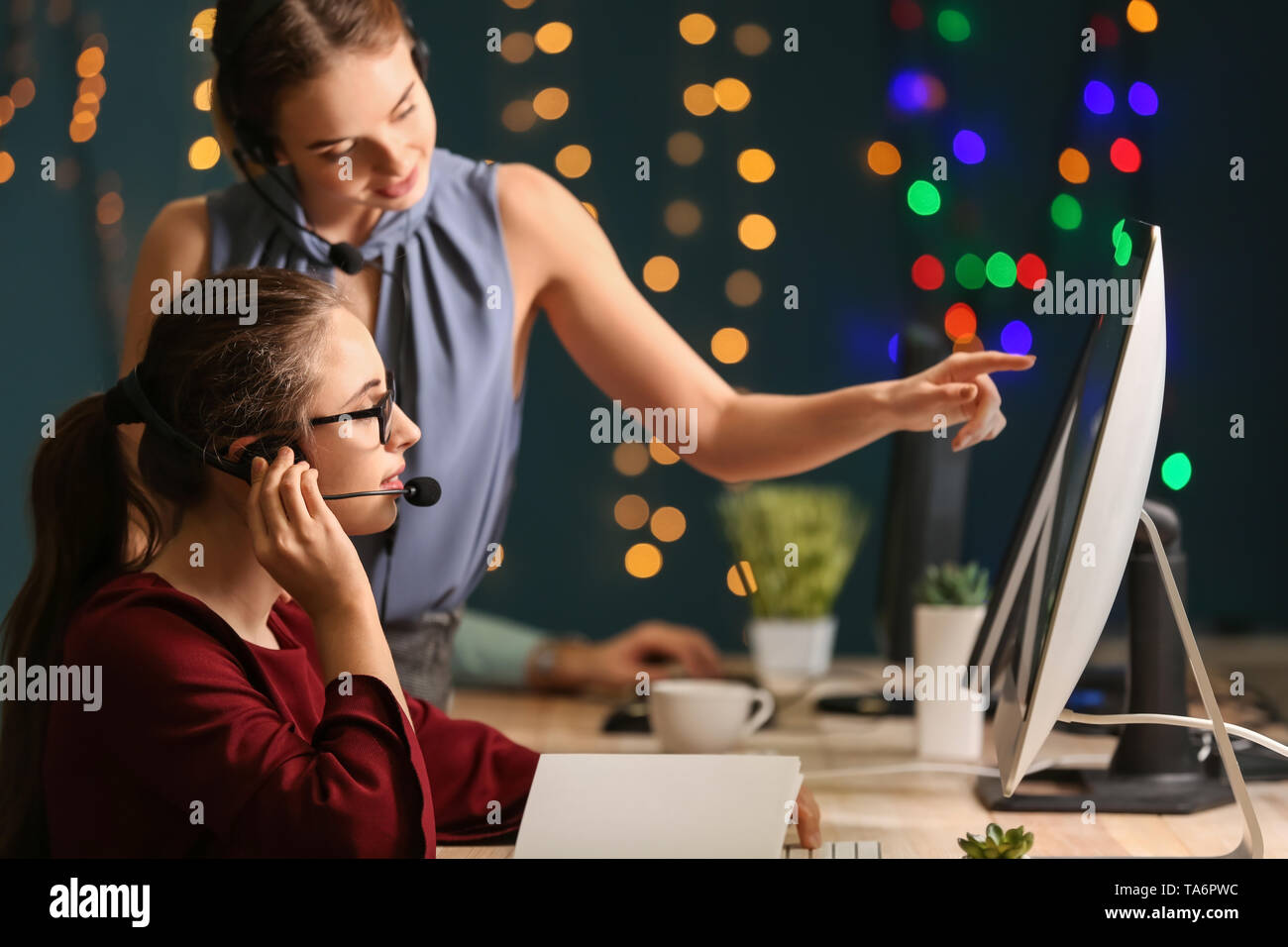 Technical support agents working in office Stock Photo - Alamy