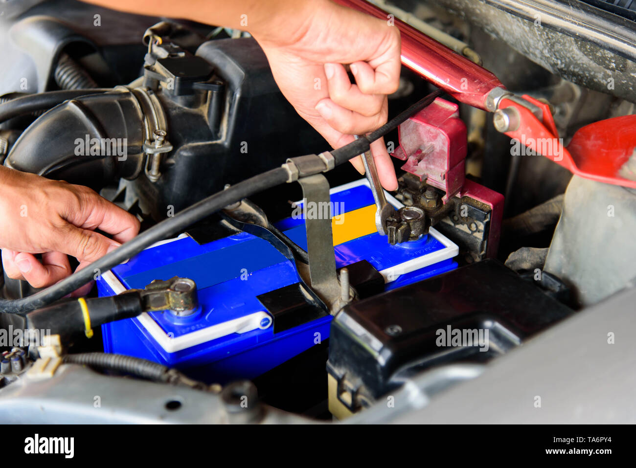The man turn wrench for Change New Battery of old car Stock Photo - Alamy
