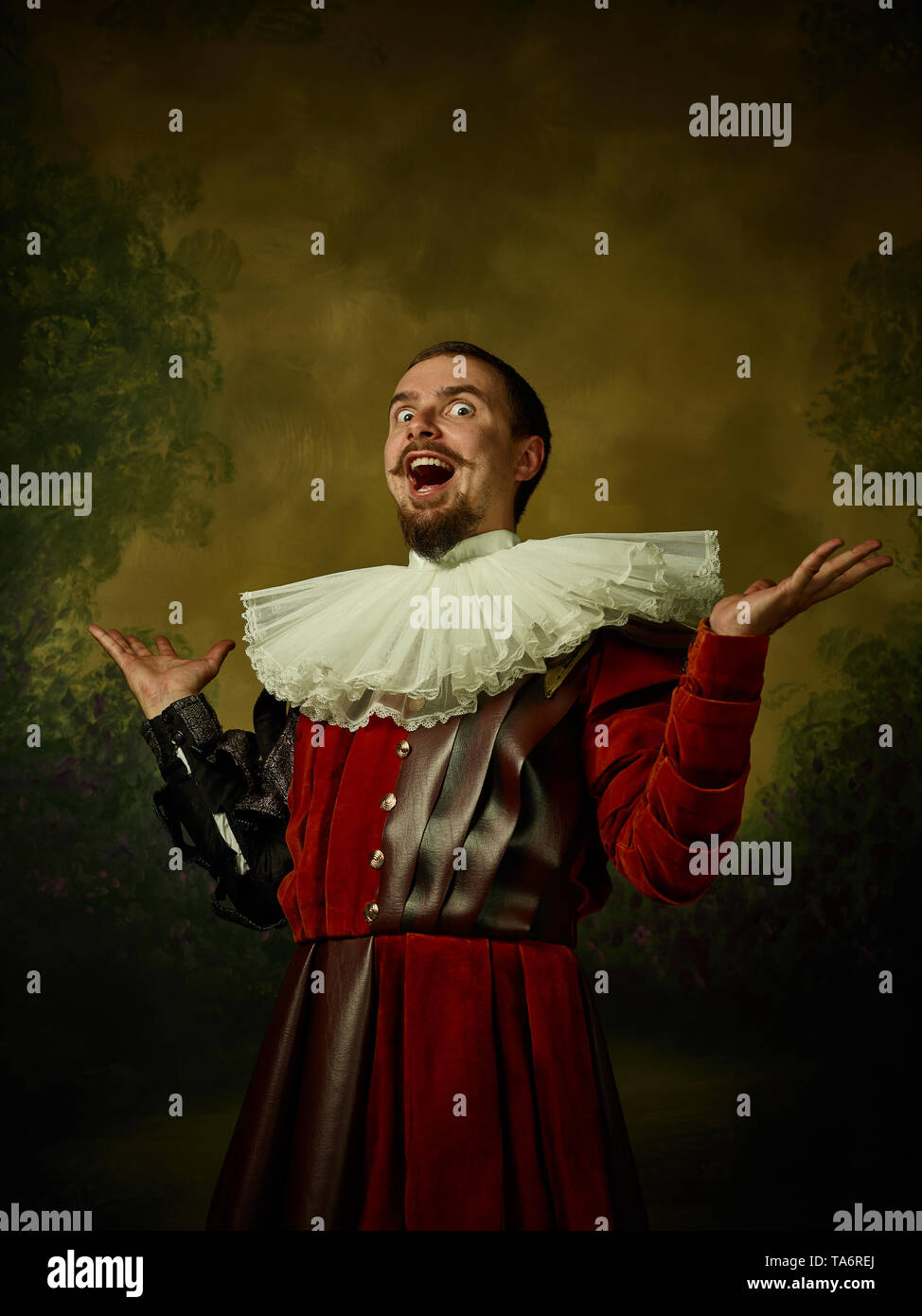 Young man as a medieval knight on dark studio background. Portrait in ...