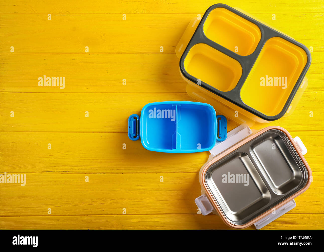 Empty school lunch boxes on color wooden background Stock Photo - Alamy