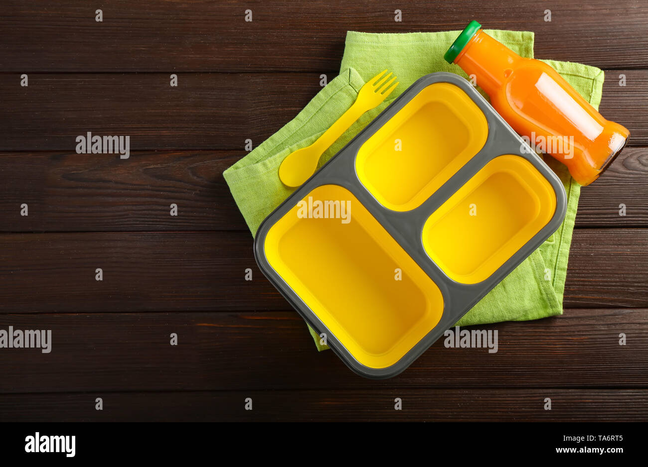 Empty school lunch box and bottle of juice on wooden background Stock ...