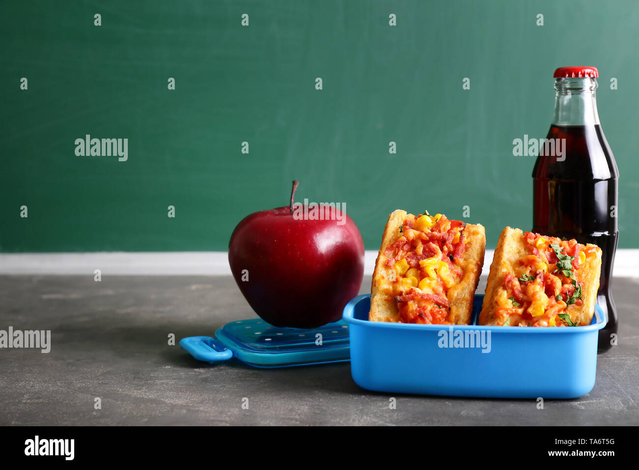 School lunch box with tasty food and soda on table Stock Photo - Alamy