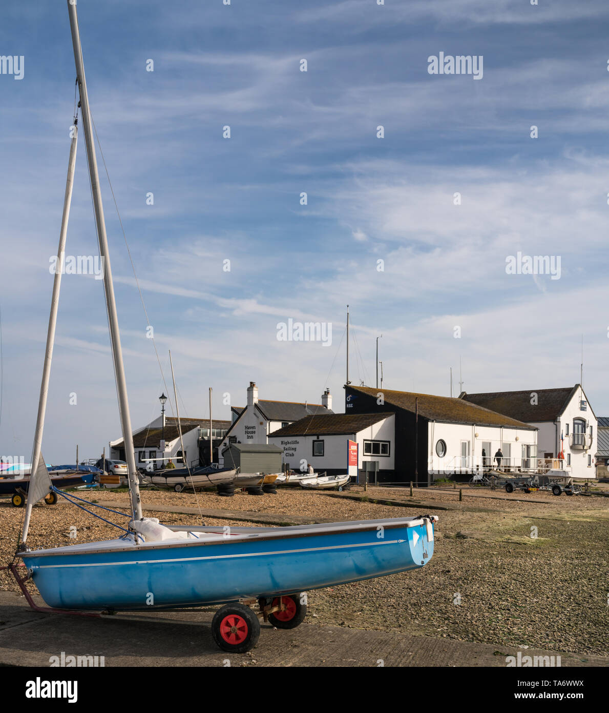 Sailing boat on Mudeford quay with lifeboat station and The Haven pub ...