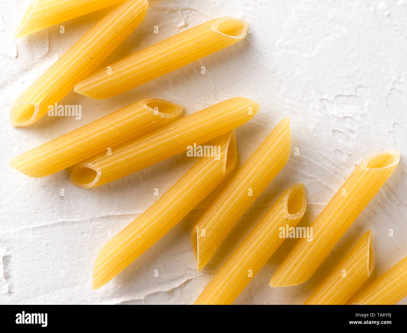 Raw pasta as food background. Italian Penne Rigate Macaroni Pasta on ...