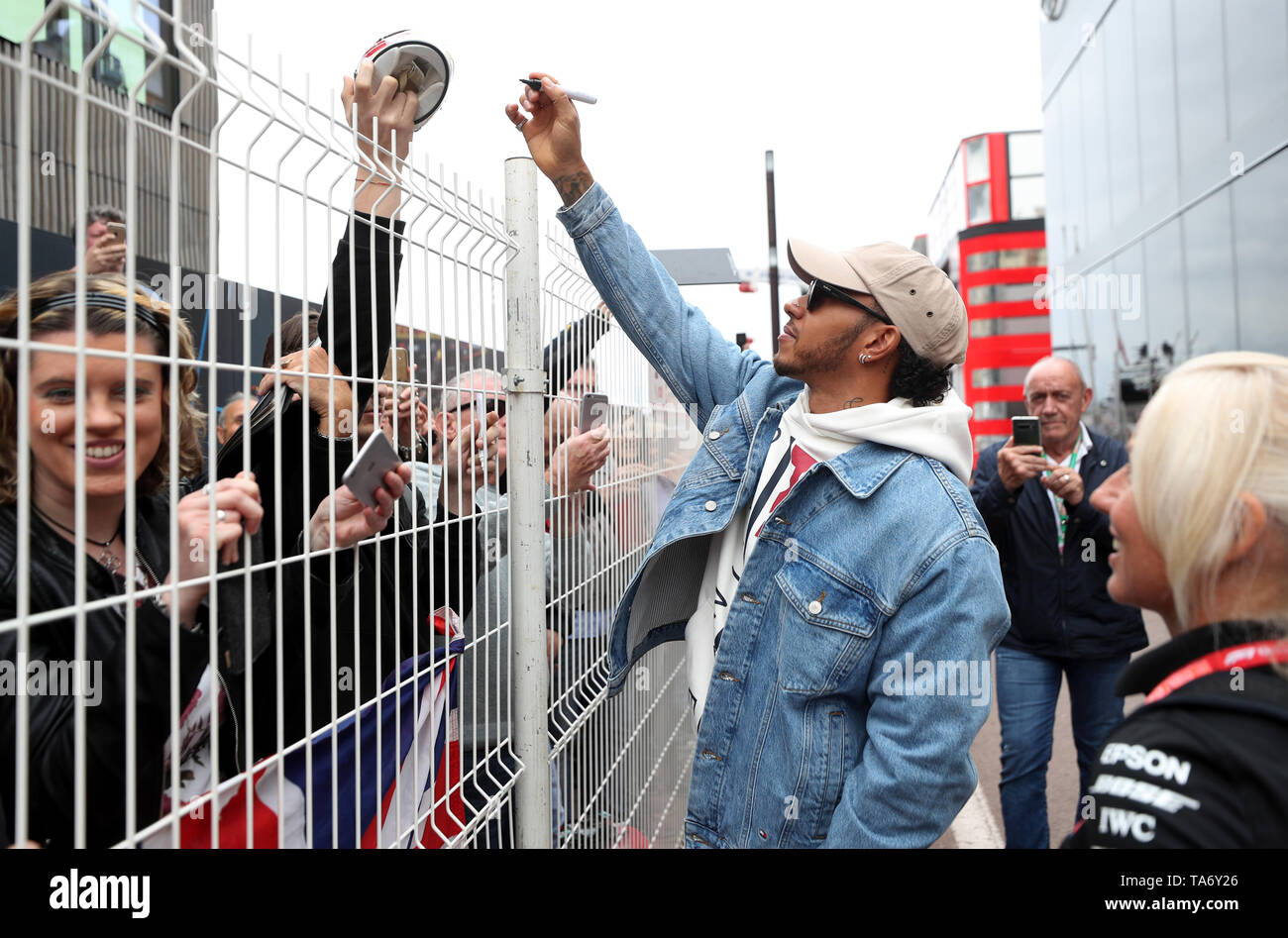 Lewis Hamilton signs autographs in the paddock at the Circuit de Monaco ...