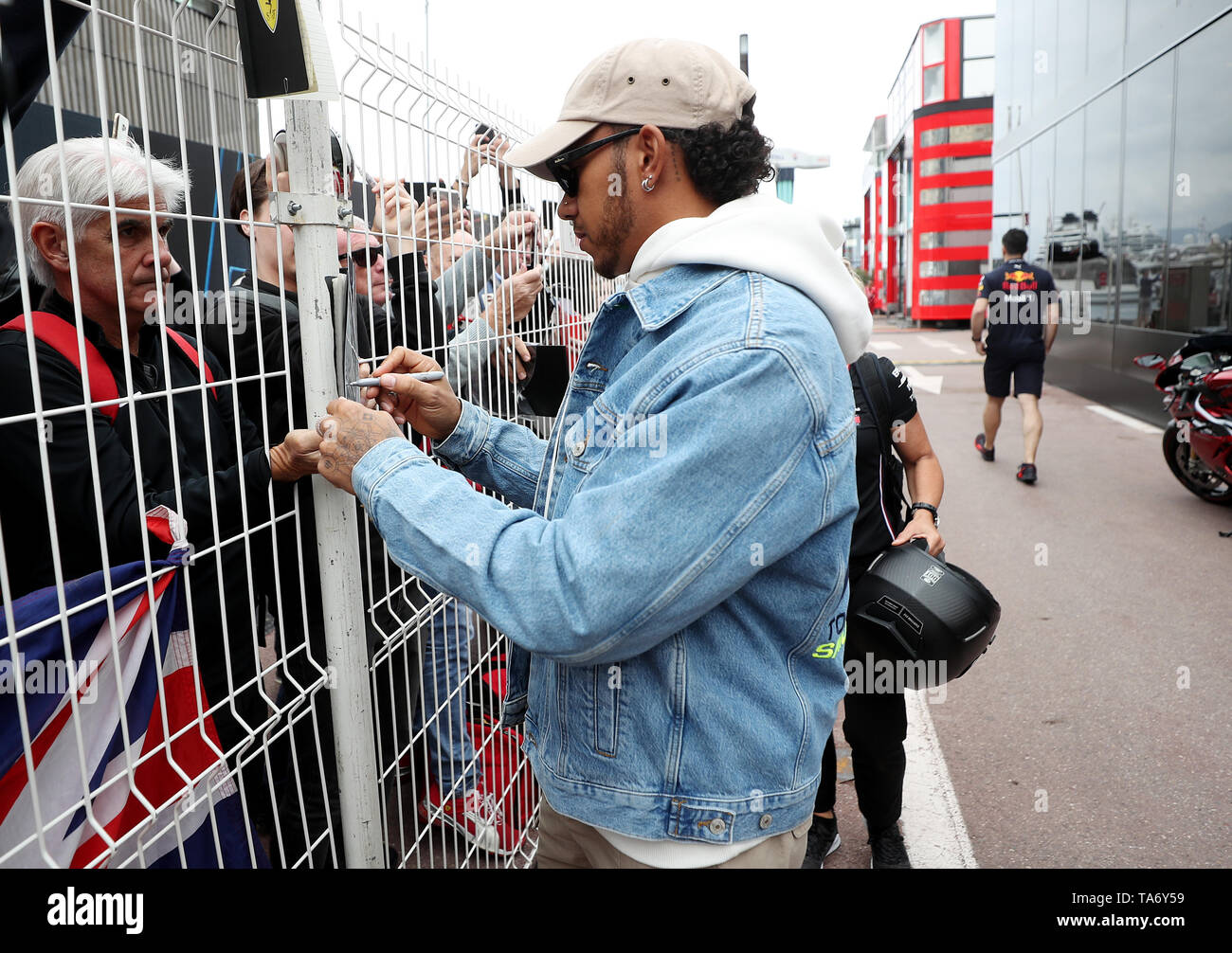 Lewis Hamilton signs autographs in the paddock at the Circuit de Monaco ...
