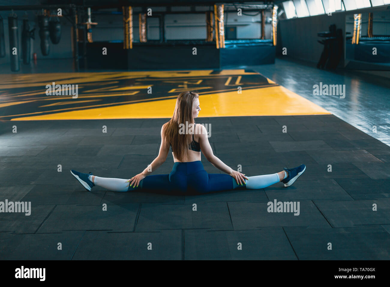 Stretching gymnast girl doing vertical split, twine. Side view of ...