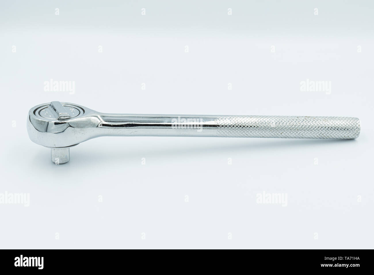 This capture of a silver socket wrench on a white background and in a ...