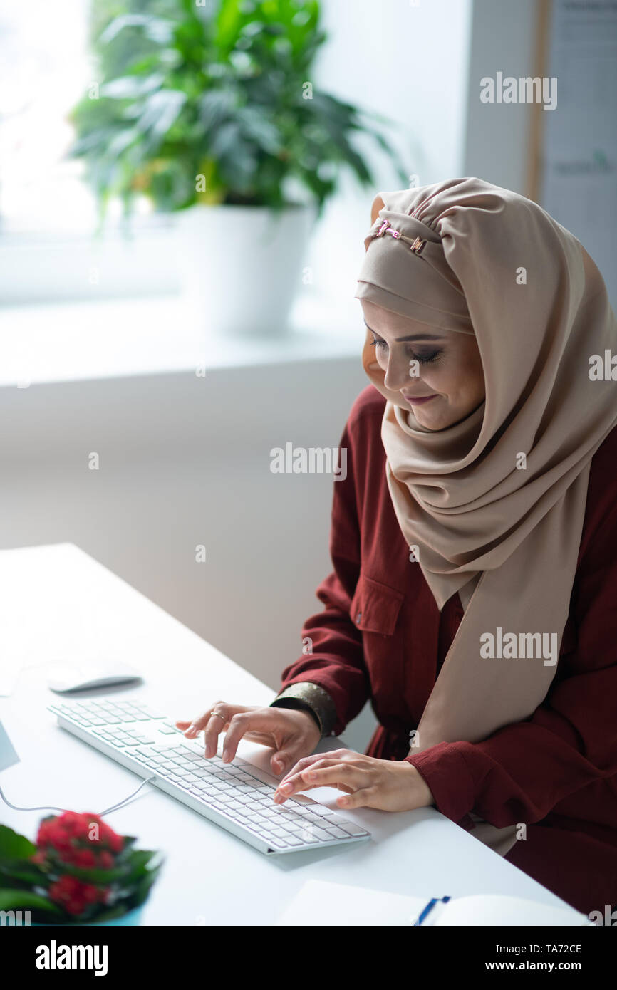 Muslim woman working home typing hi-res stock photography and images ...