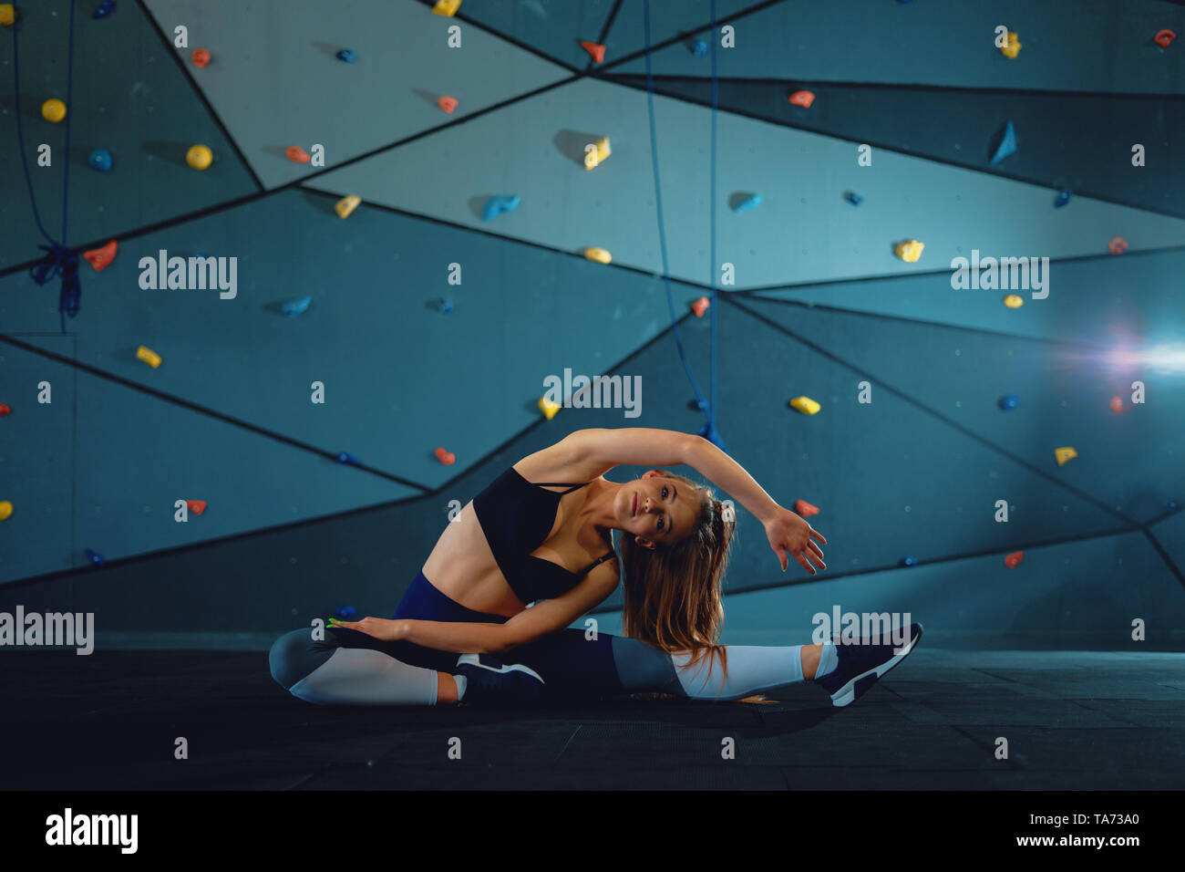 Stretching gymnast girl doing vertical split, twine. Front view of ...