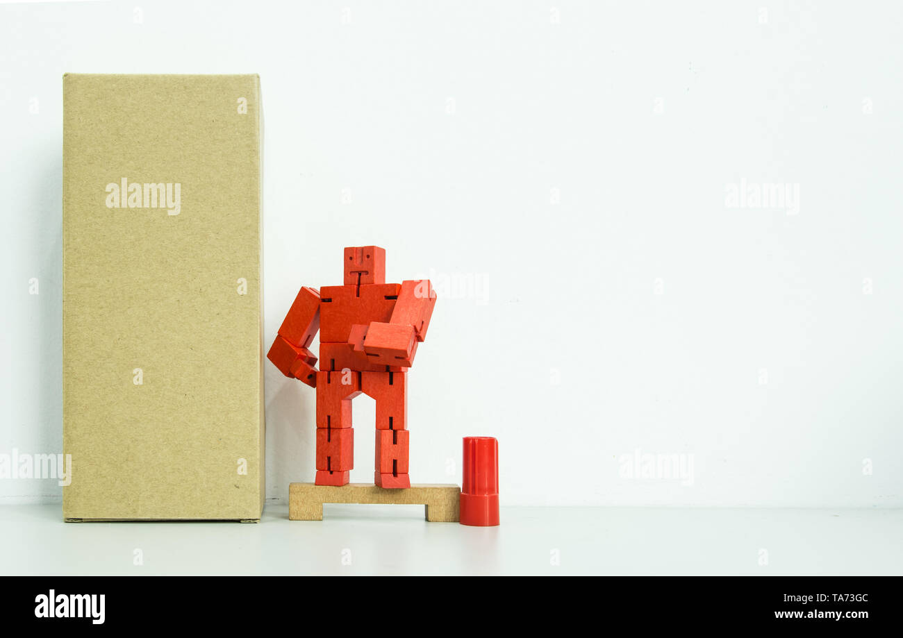 red wooden toy robot display on white background Stock Photo - Alamy