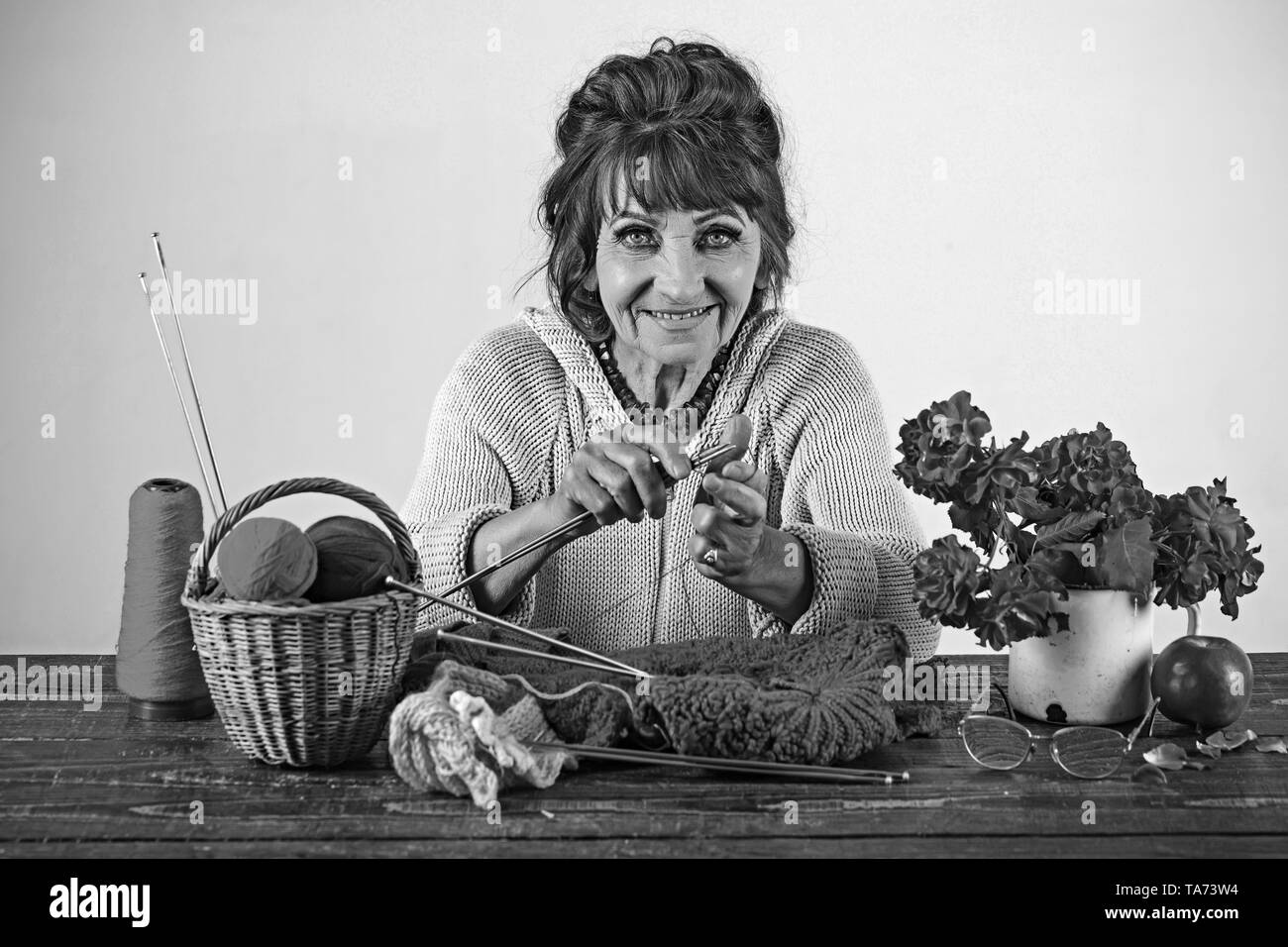 Old woman knitting socks from colorful thread Stock Photo - Alamy