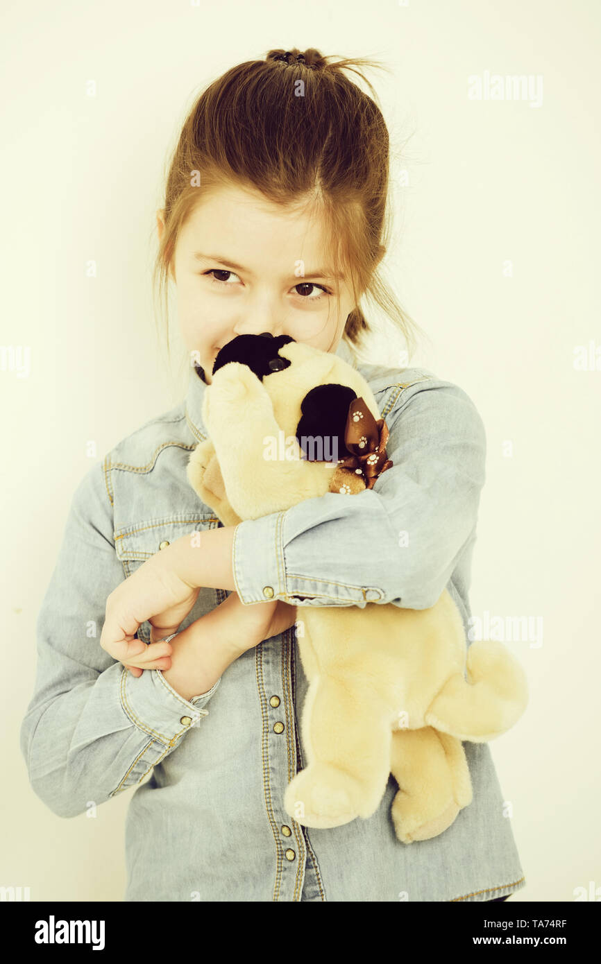 Pretty girl cuddling adorable toy puppy Stock Photo - Alamy