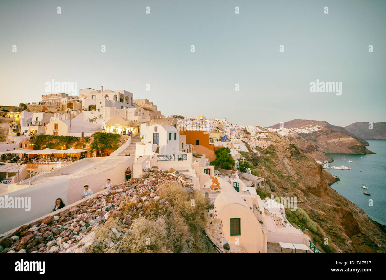 SANTORINI, GREECE - JUNE 2014: Sunset view of Oia buildings and streets ...