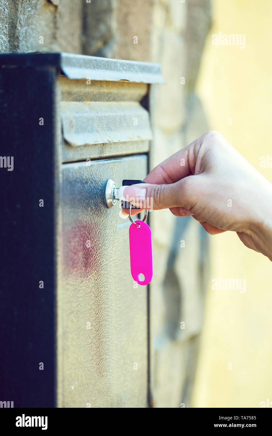 Female hand opens post box Stock Photo - Alamy