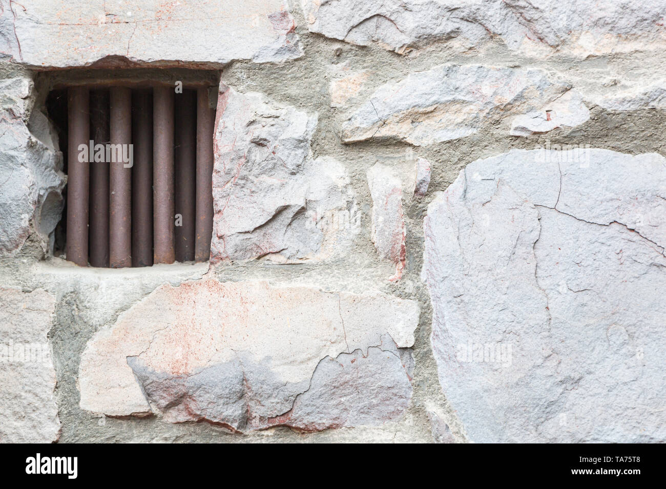 Old Stone Wall With Small Iron Barred Prison Cell Window Stock Photo ...
