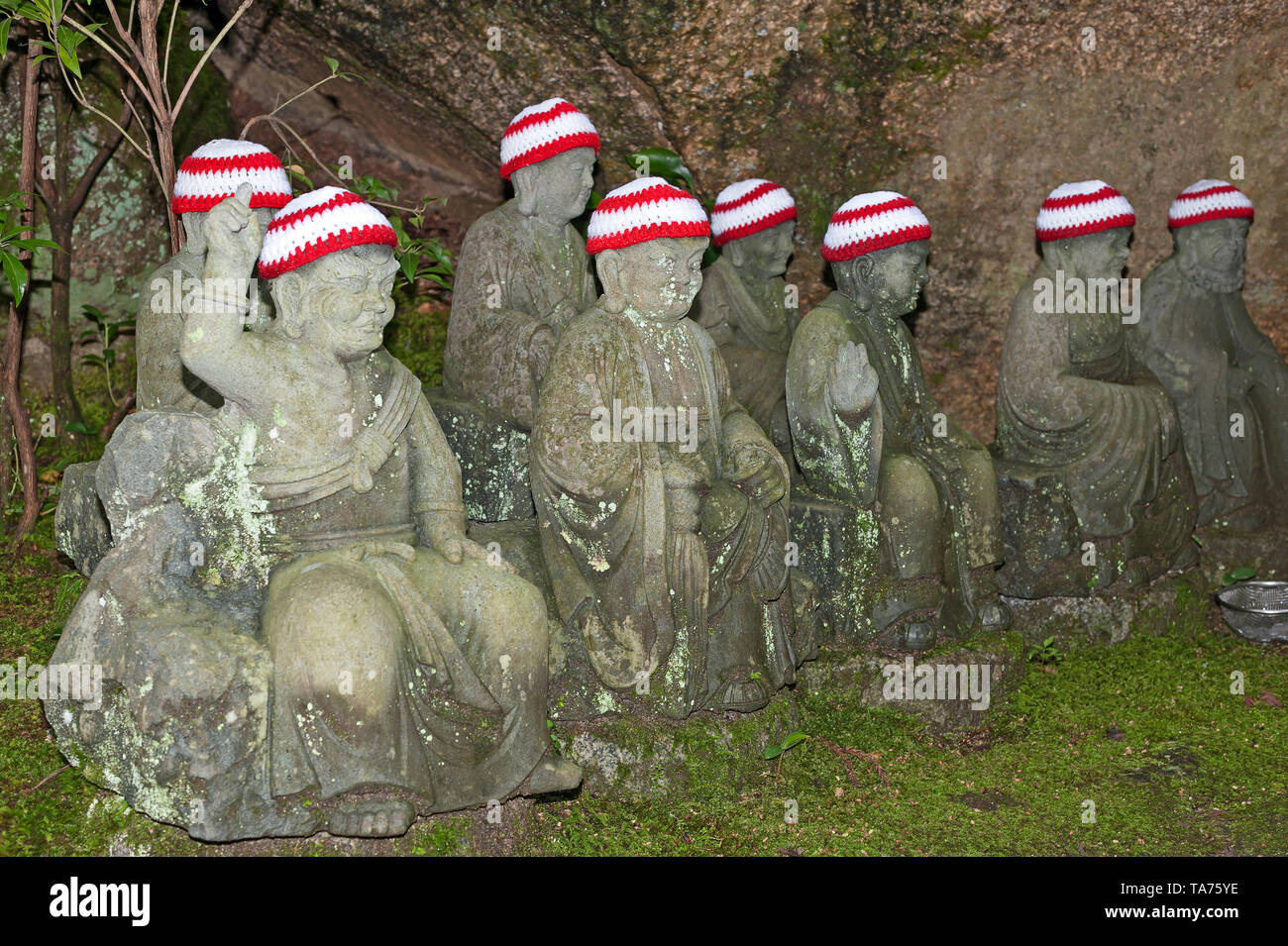 Jizo Bosatsu, statues of buddhist monks wearing red and white caps in ...