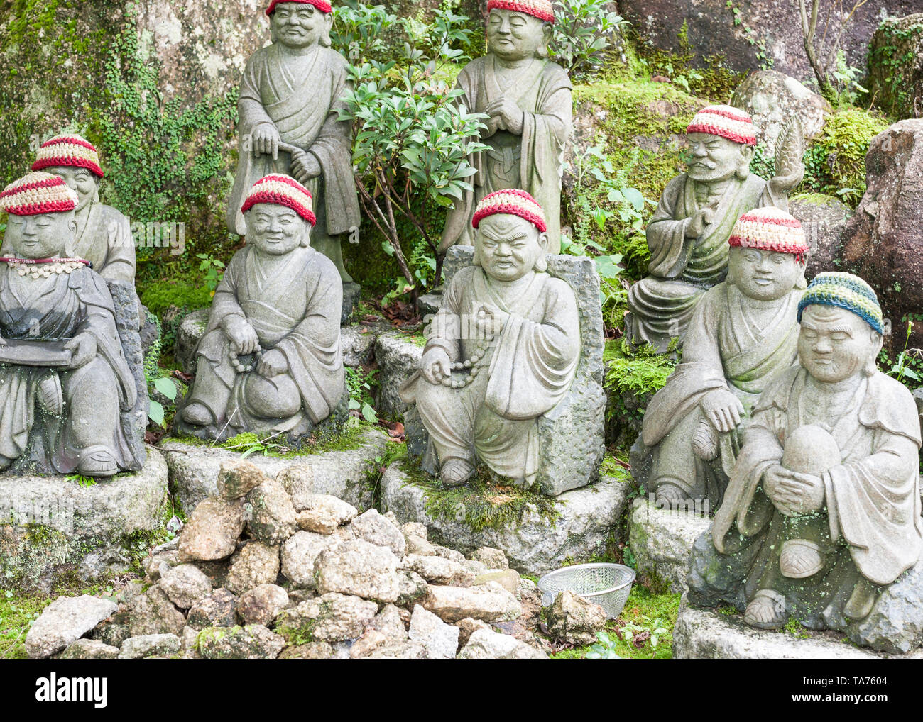 Jizo Bosatsu, statues of buddhist monks wearing red and white caps in ...
