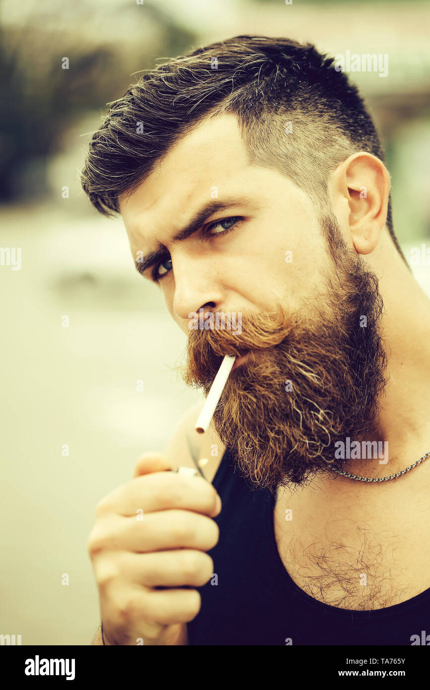 Bearded man lights cigarette hi-res stock photography and images - Alamy