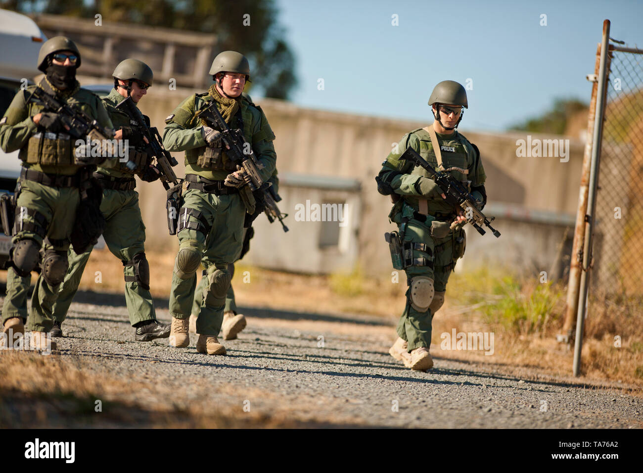 Four police officers holding their guns at a training facility Stock ...