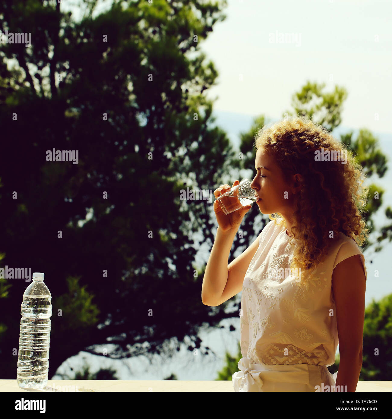 Pretty girl drinks water Stock Photo - Alamy