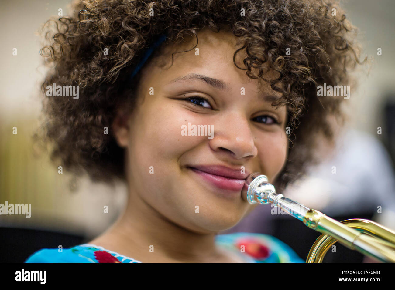 Young woman playing musical instrument Stock Photo - Alamy