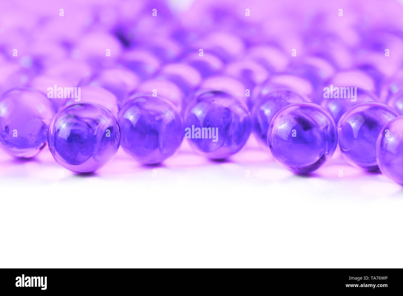 proton purple spherical ball capsules with selective focus isolated on ...