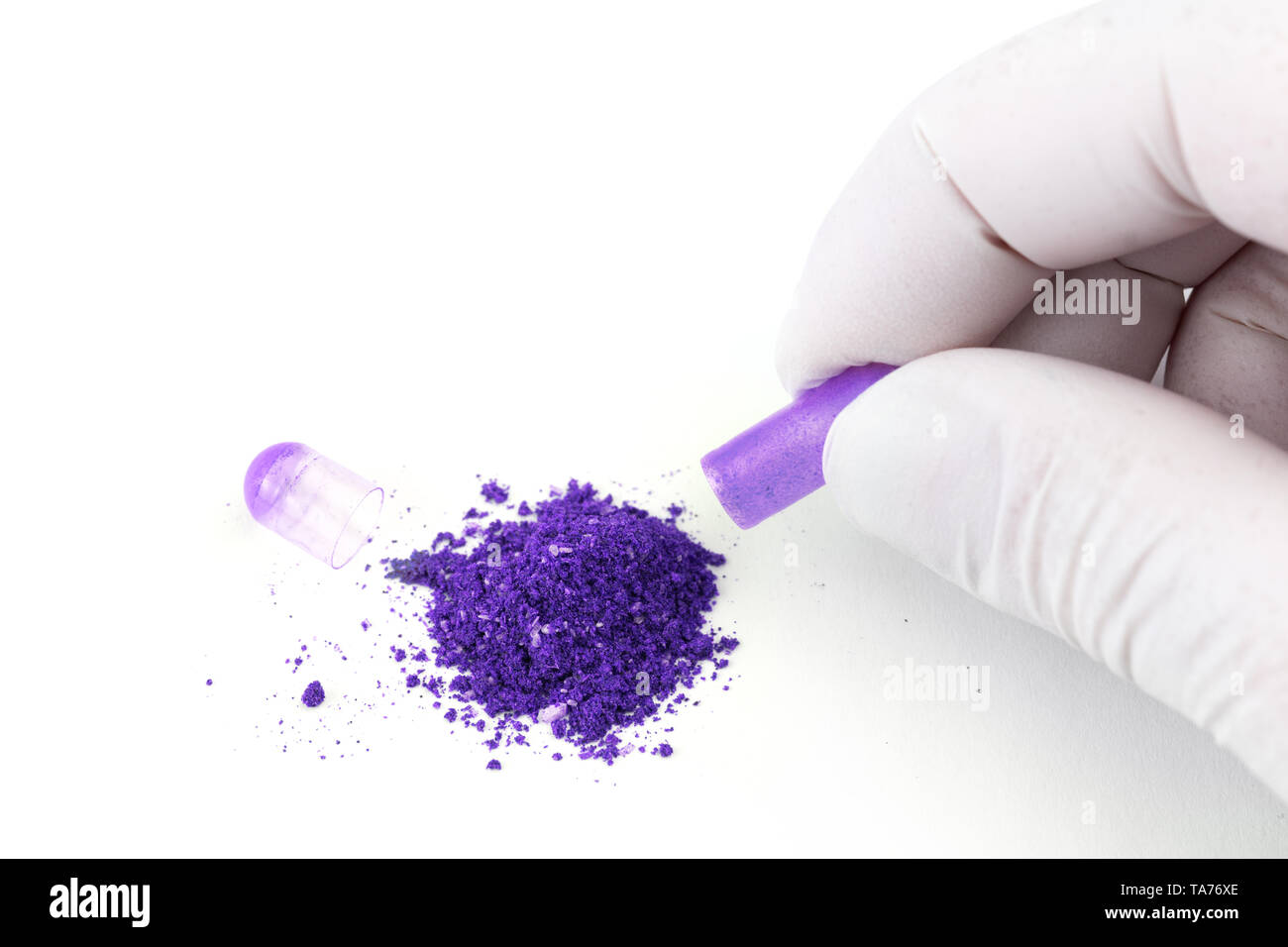 hand in medical glove opening proton purple color organic med capsule ...