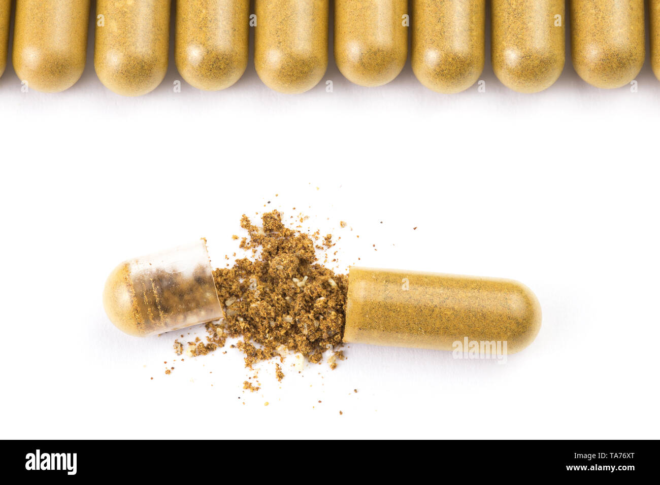 row of orange color organic capsules isolated on white background ...