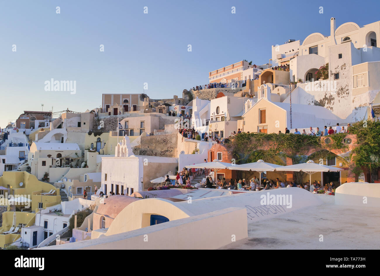 SANTORINI, GREECE - JUNE 2014: Sunset view of Oia buildings and streets ...