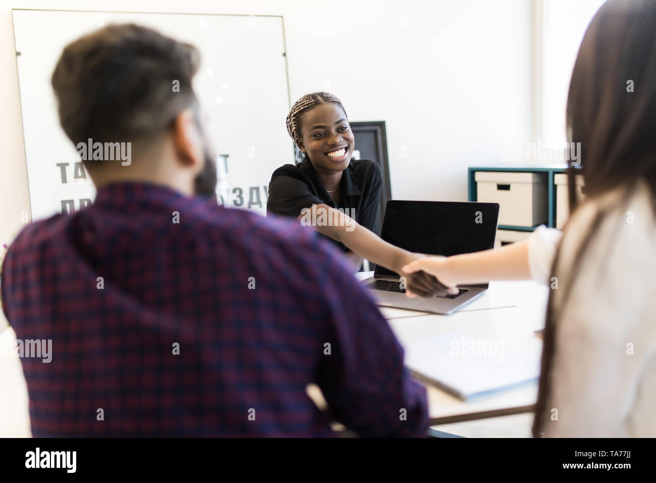African american hr team welcoming female applicant at job interview ...