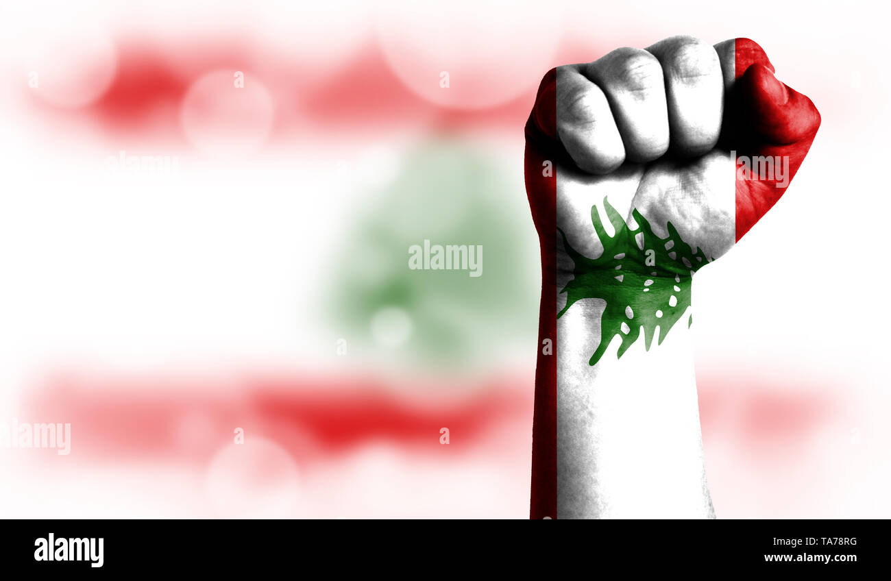 Flag of Lebanon painted on male fist, strength,power,concept of ...