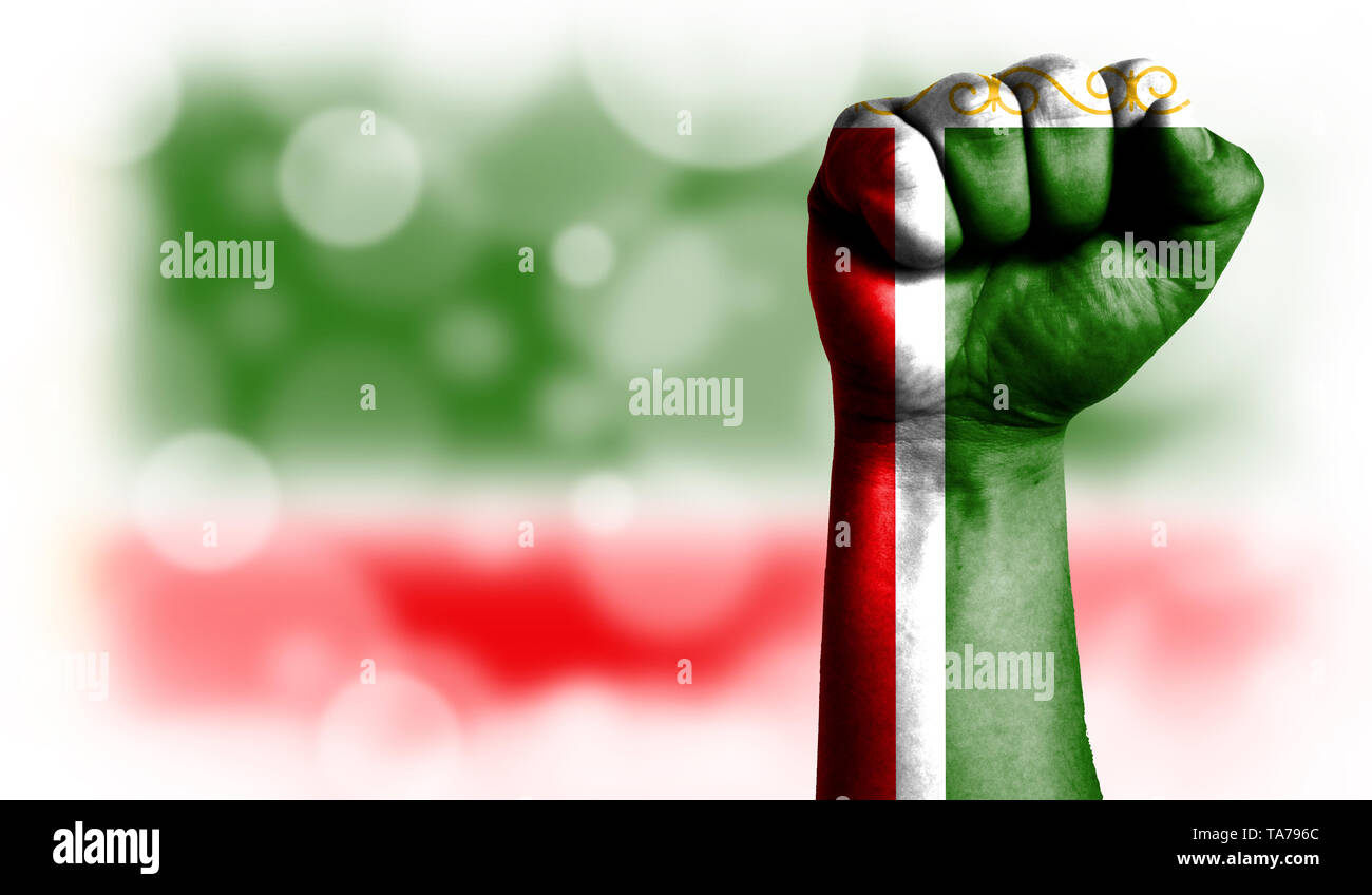 Flag of Chechen Republic painted on male fist, strength,power,concept ...
